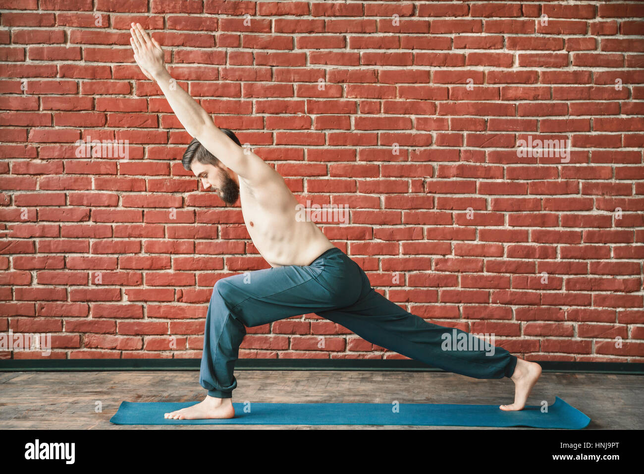 Handsome man doing yoga positions Stock Photo - Alamy
