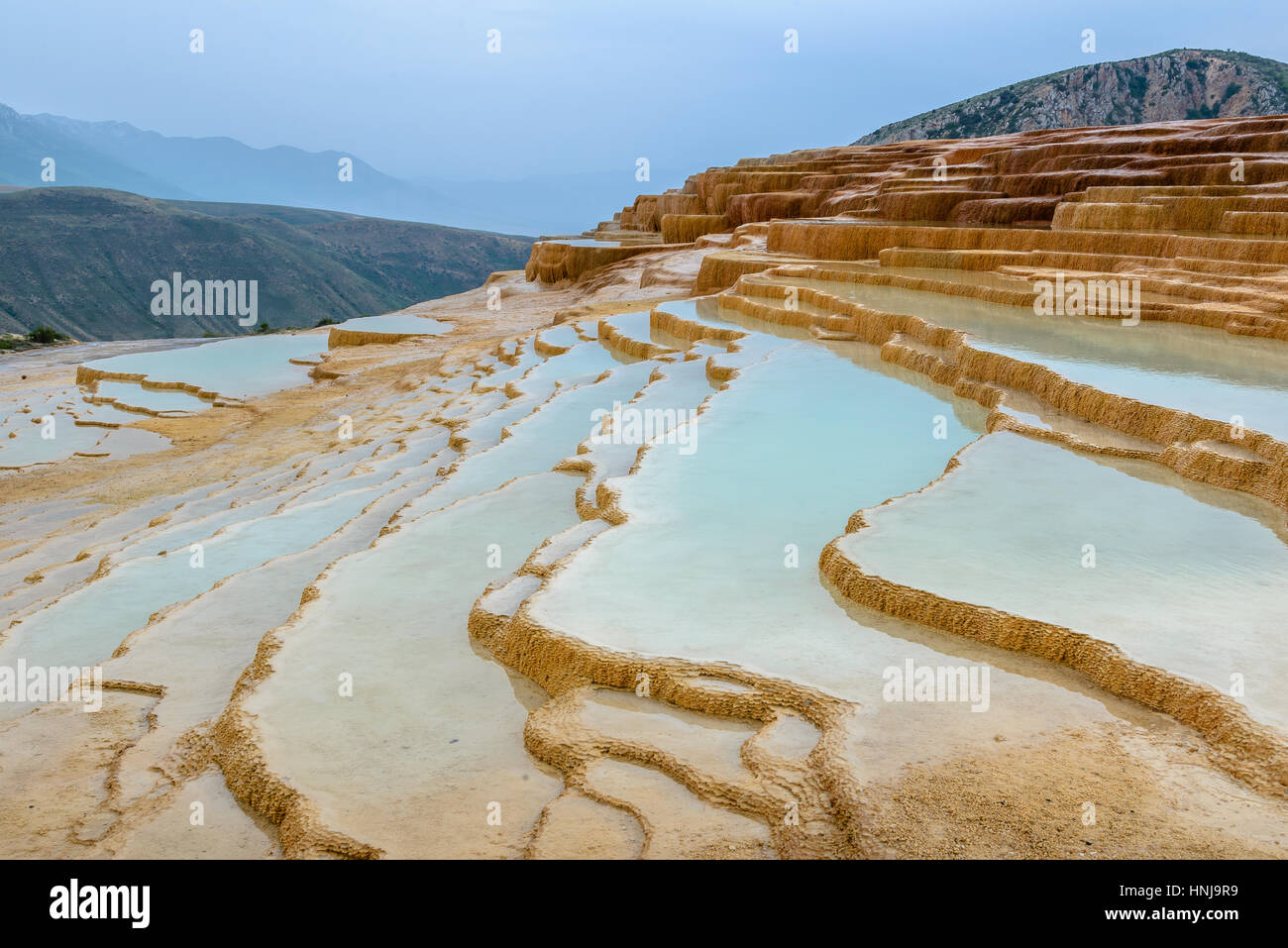 Travertine terrace at sunrise near Orost, one of the rare pure ...