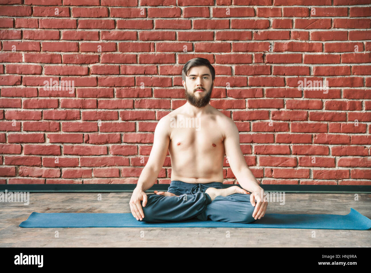 Attractive man doing yoga Stock Photo - Alamy