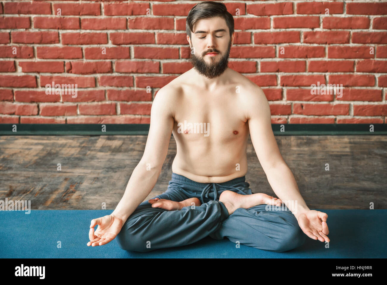 Handsome man doing yoga positions Stock Photo - Alamy