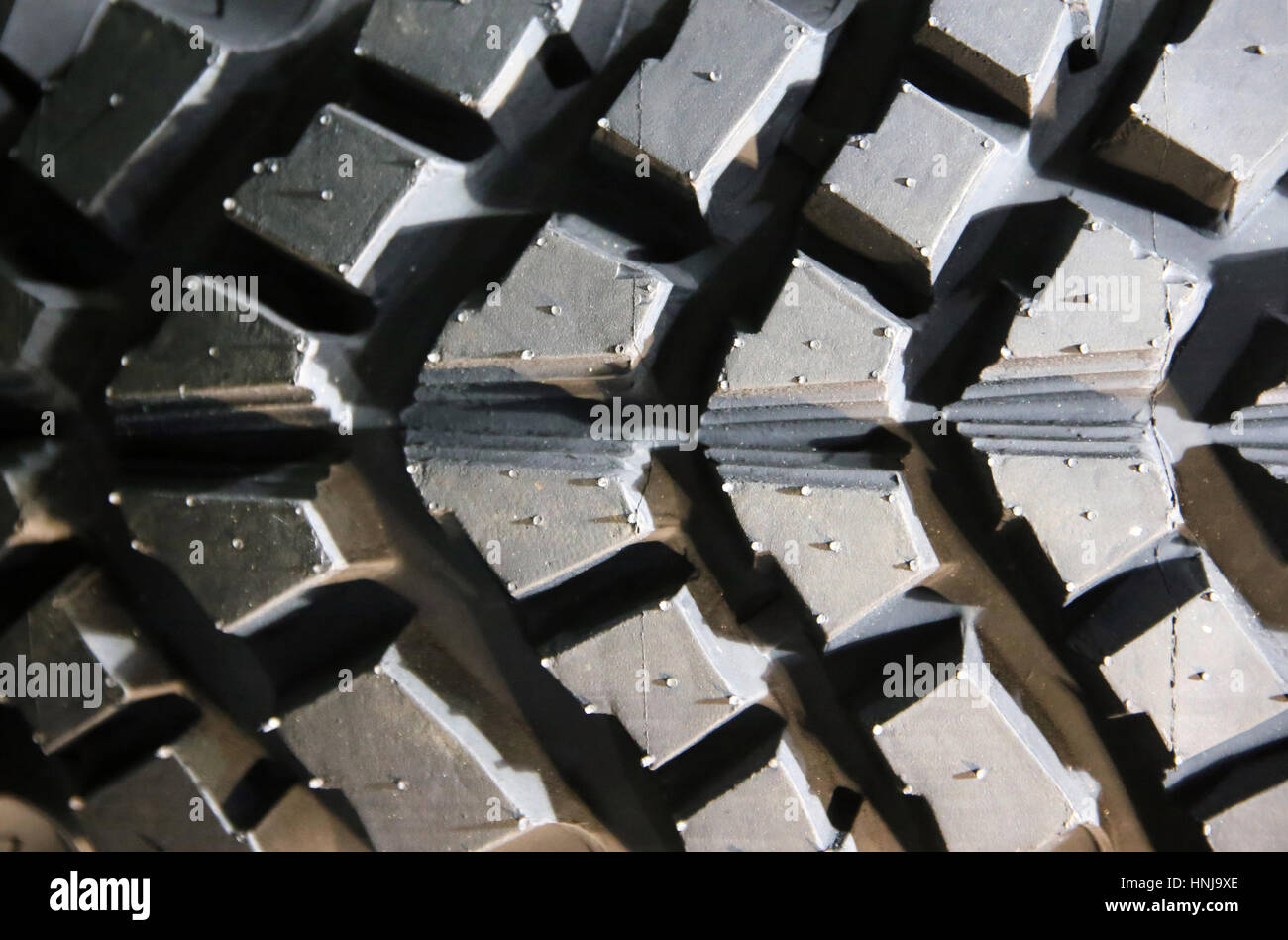 Close up of a brand new tire of a 4x4 car. Color detail shot of an off ...