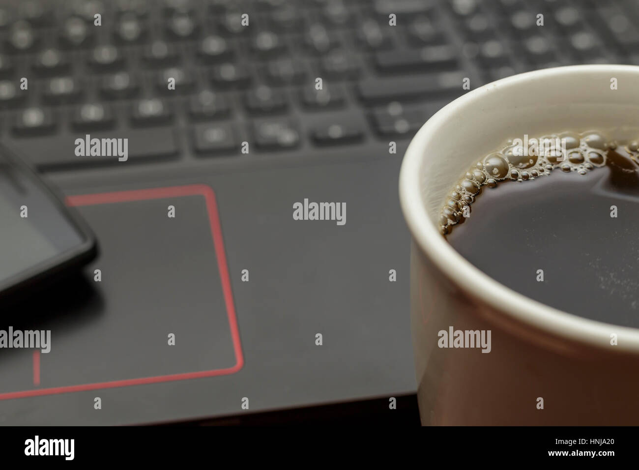 cup of coffee in front of a laptop computer Stock Photo - Alamy