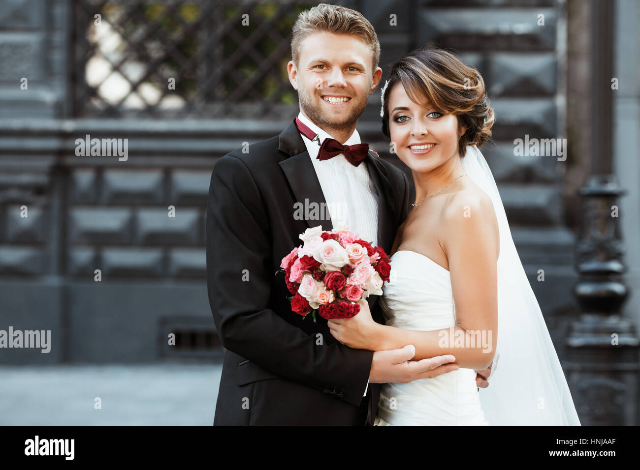 Bride and bridegroom holding bouquet Stock Photo - Alamy
