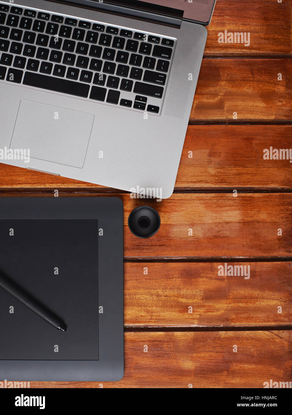 designer wood desk with modern laptop and graphic tablet vertical ...