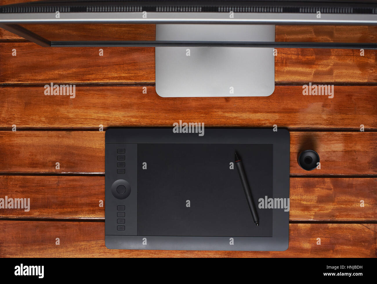 working space of graphic designer on wooden table with computer and ...