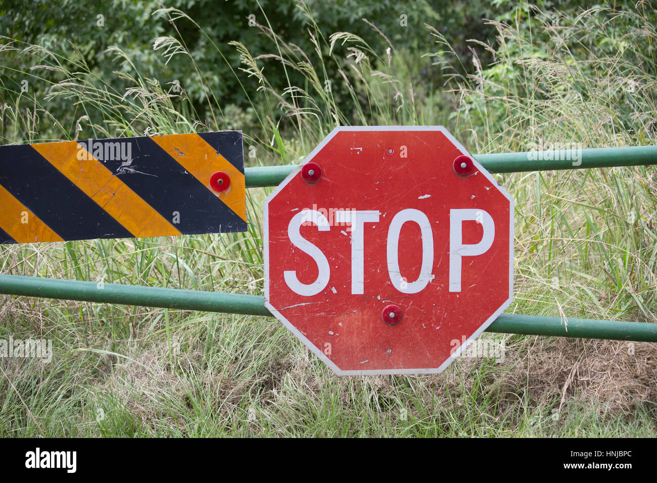Stop sign on an open fence to a field Stock Photo - Alamy
