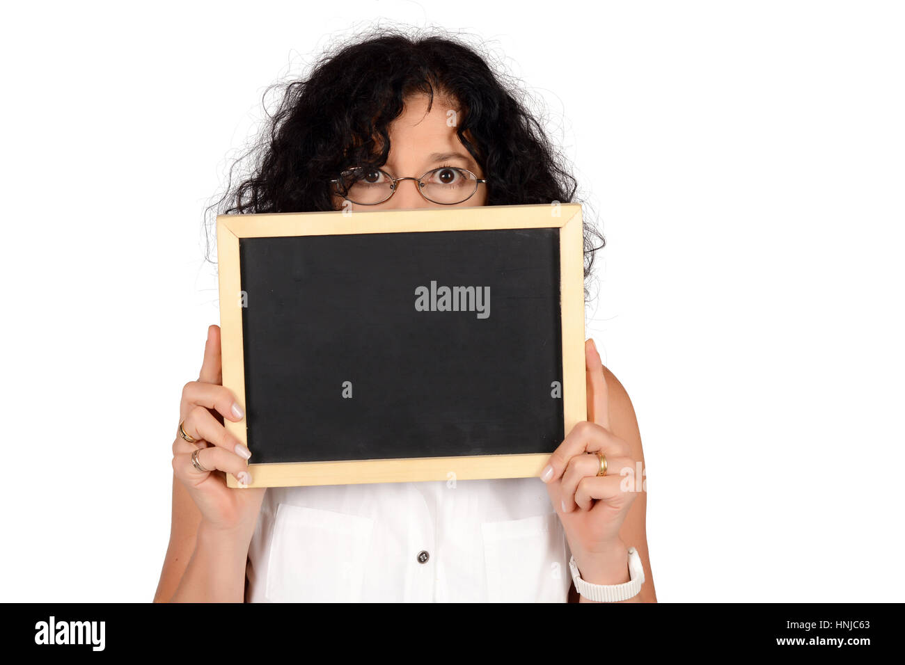 Portrait of beautiful school teacher holding an empty chalkboard ...