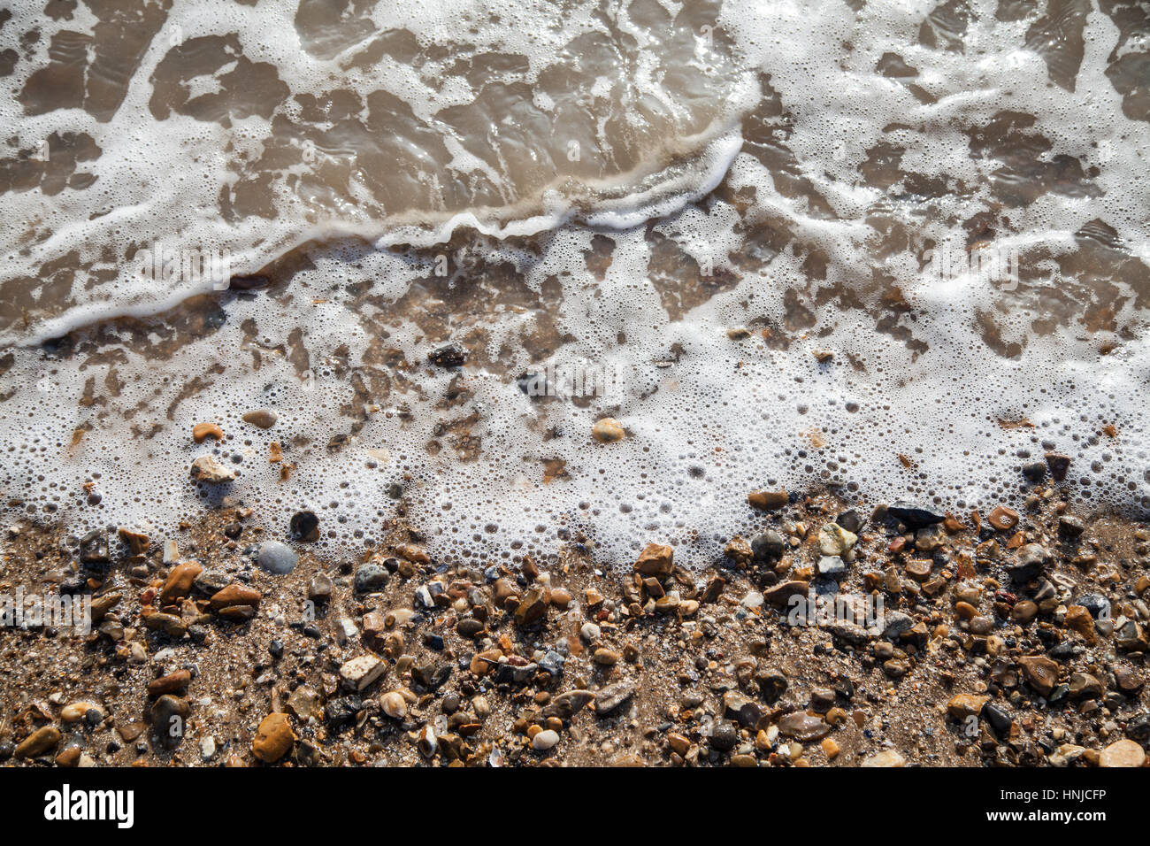 Tide washing up on the beach Stock Photo - Alamy
