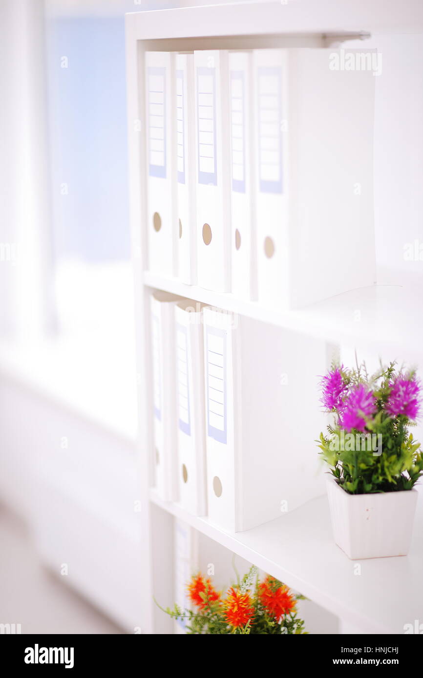 File folders, standing on shelves in background Stock Photo - Alamy