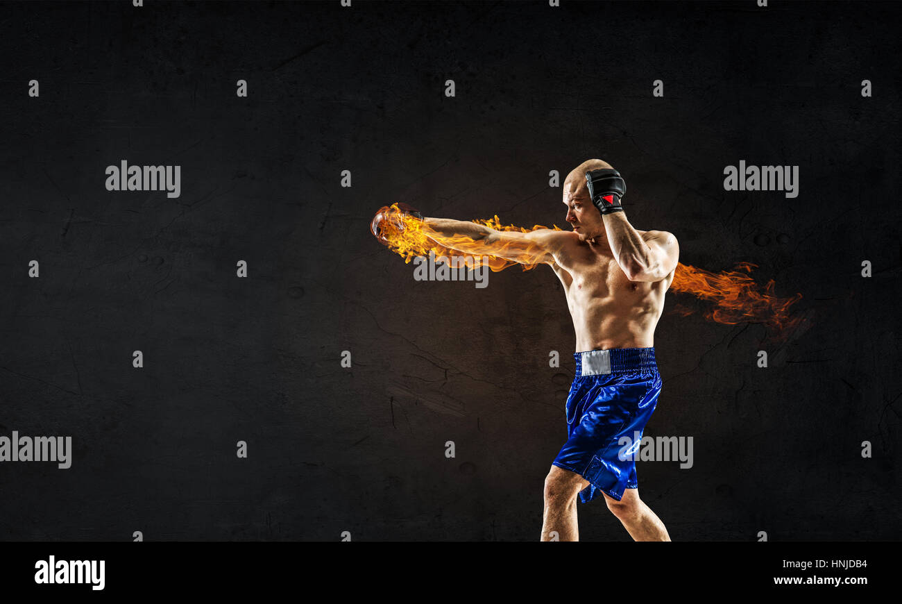 Strong determined box fighter against concrete wall background. Mixed ...