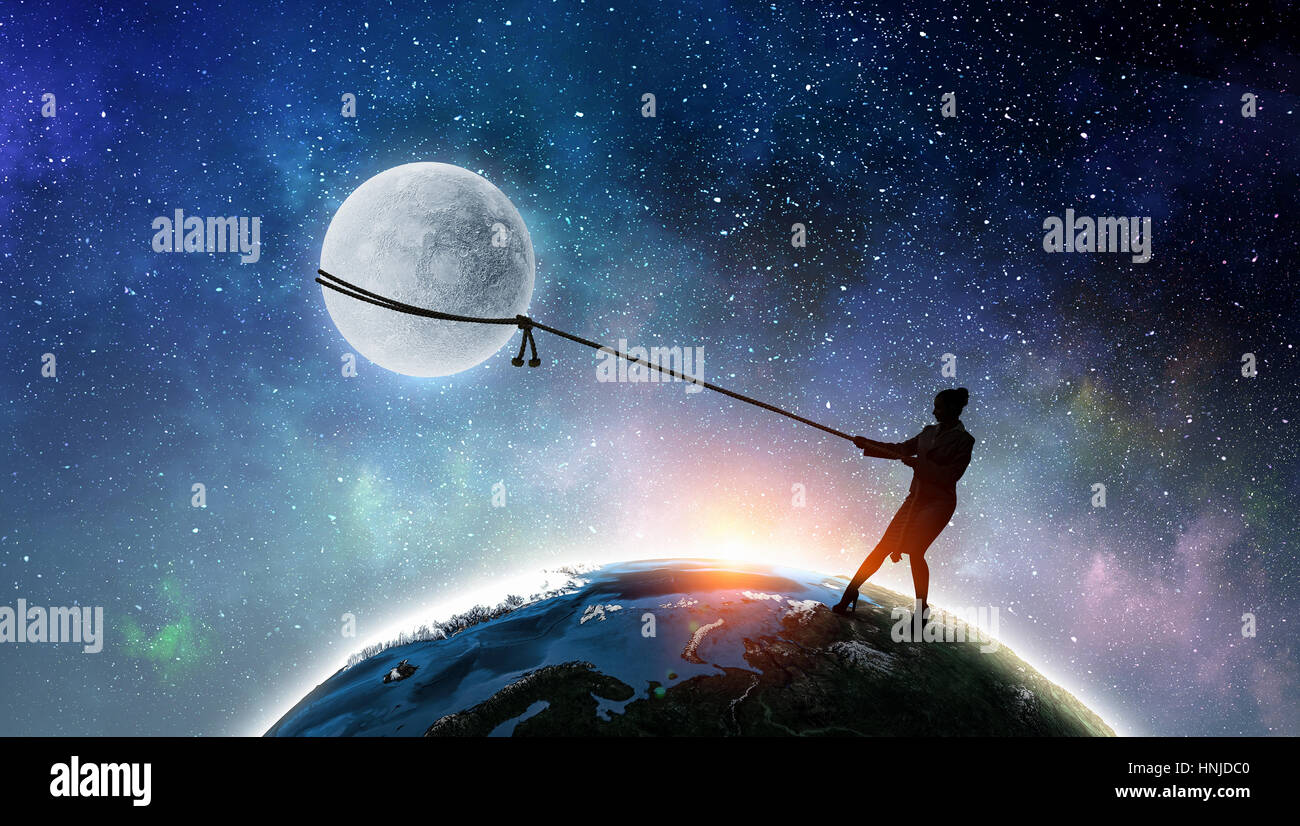 Silhouette of woman against starry sky catching moon. Elements of this ...