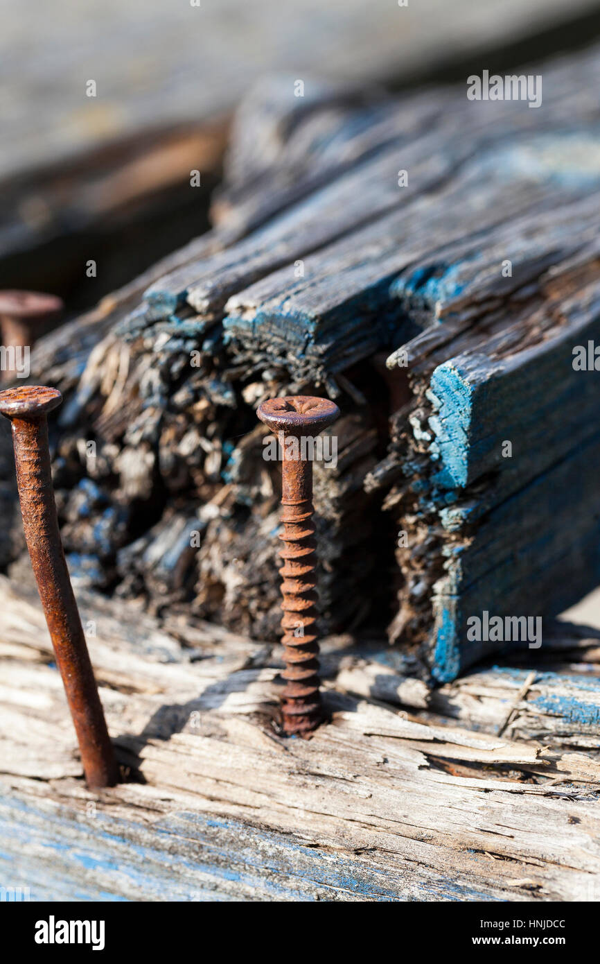 photographed close up old rusty screw that secures the board broken ...
