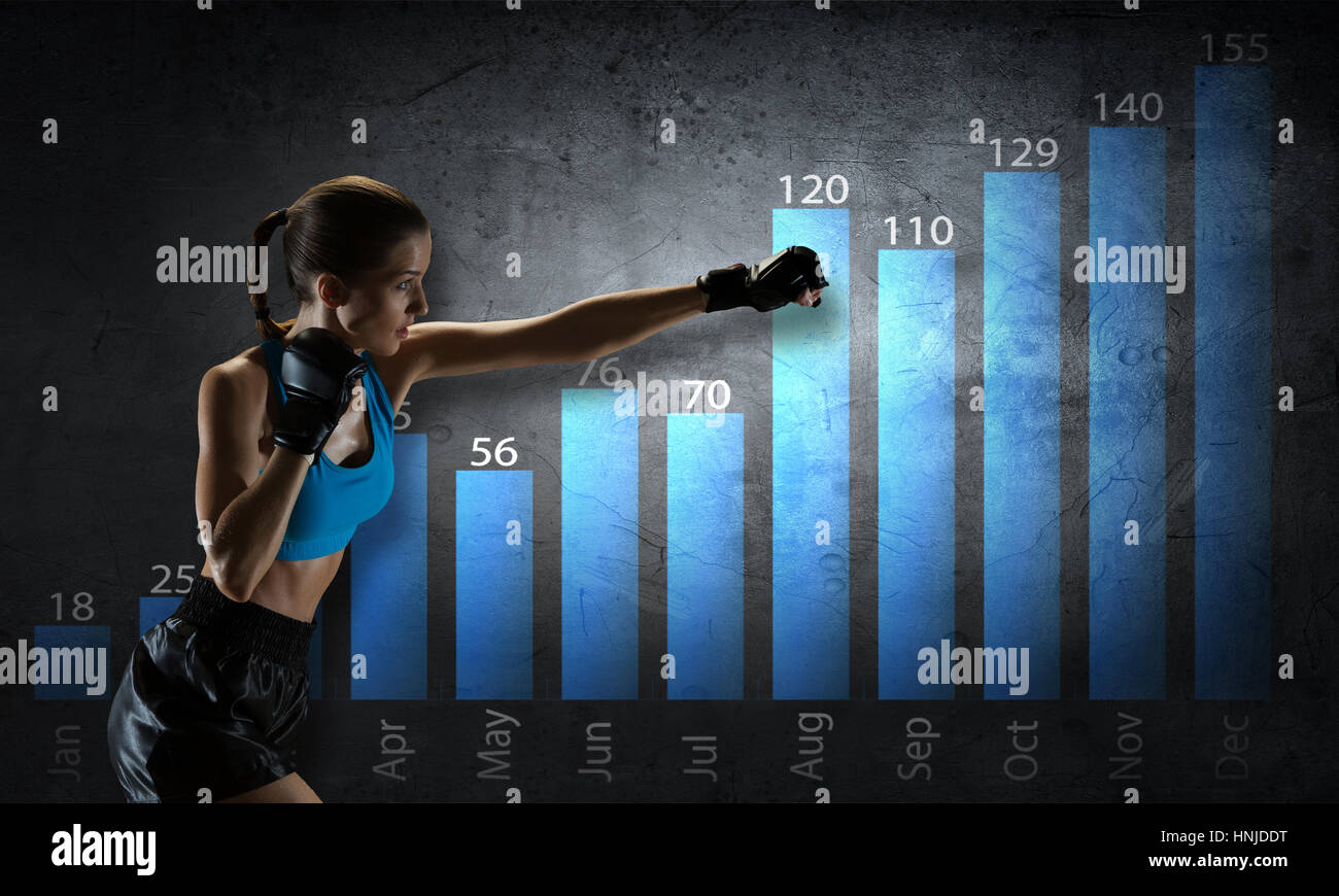 Young woman boxing against graphs background. Mixed media Stock Photo ...