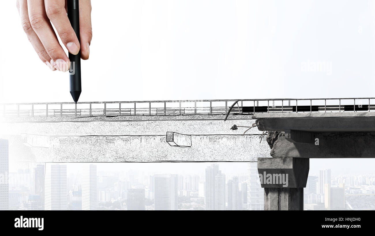 Hand of female drawing elements of crashed bridge Stock Photo - Alamy