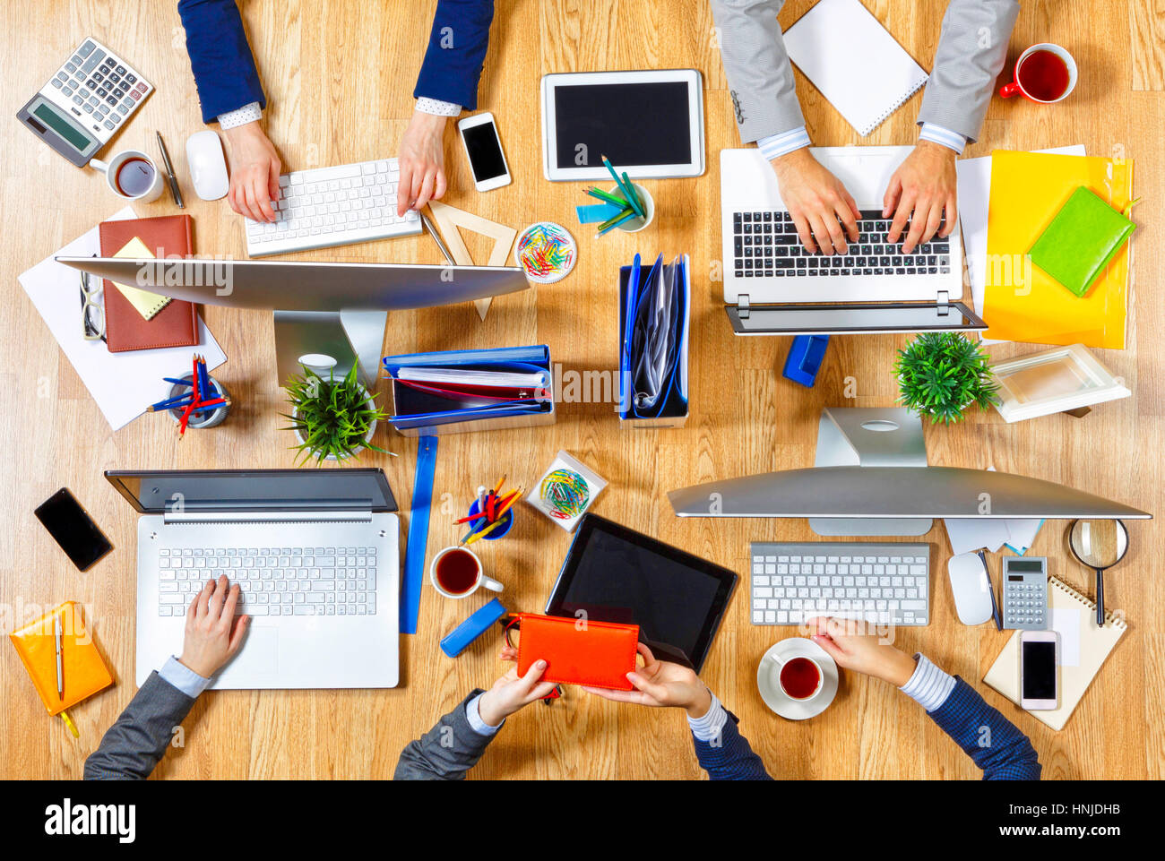 Top view of office table with four colleagues working together Stock ...