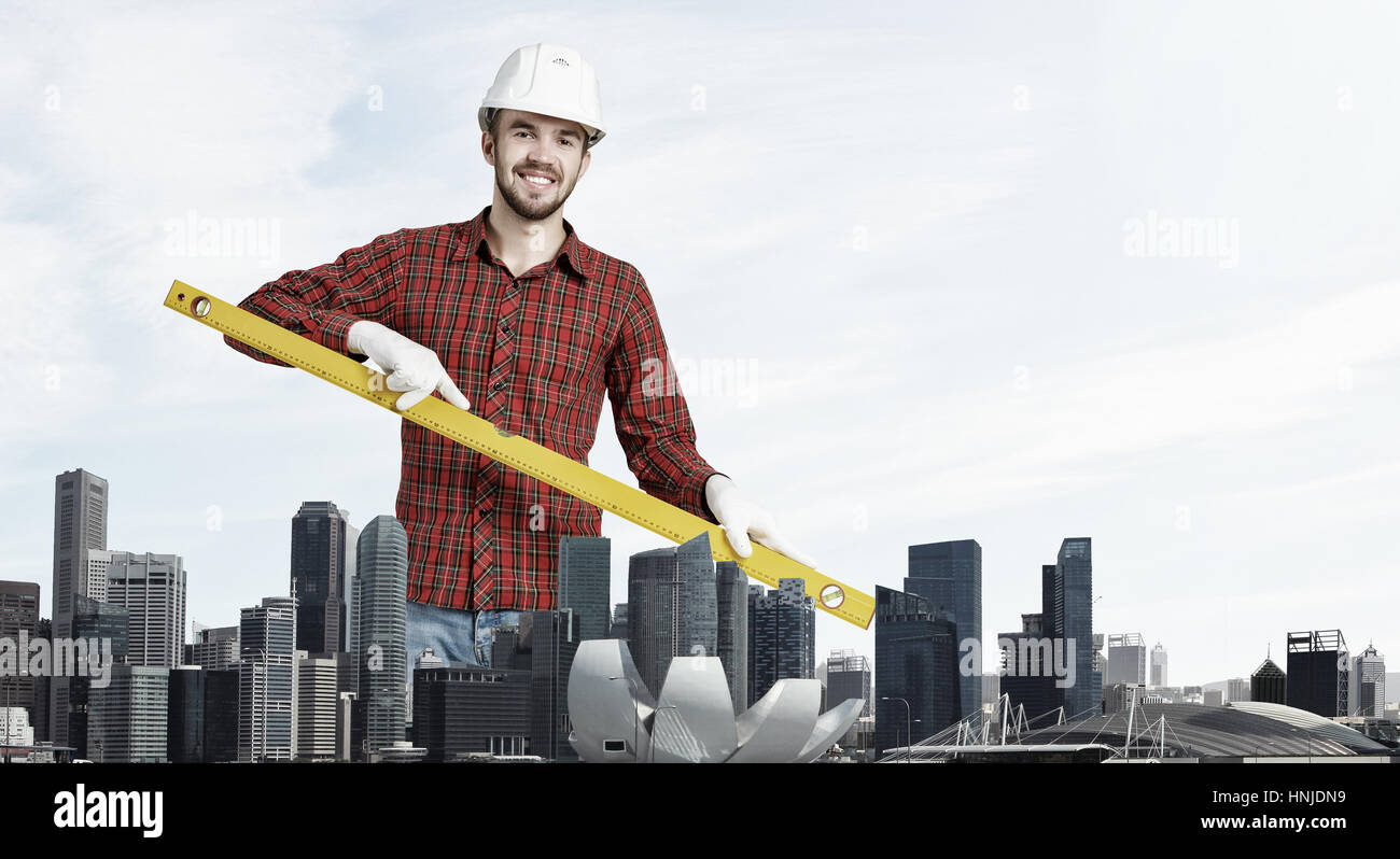 Young handsome man in hardhat with measure level Stock Photo - Alamy