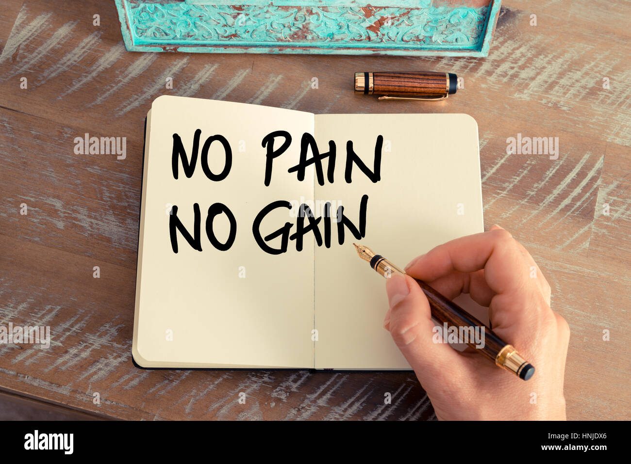 Retro effect and toned image of a woman hand writing a note with a ...