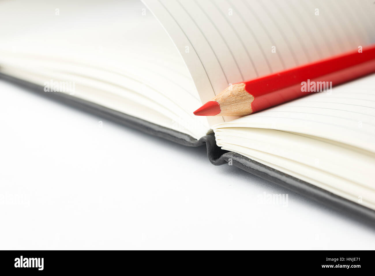Colored pencil is inside the open notebooks Stock Photo - Alamy