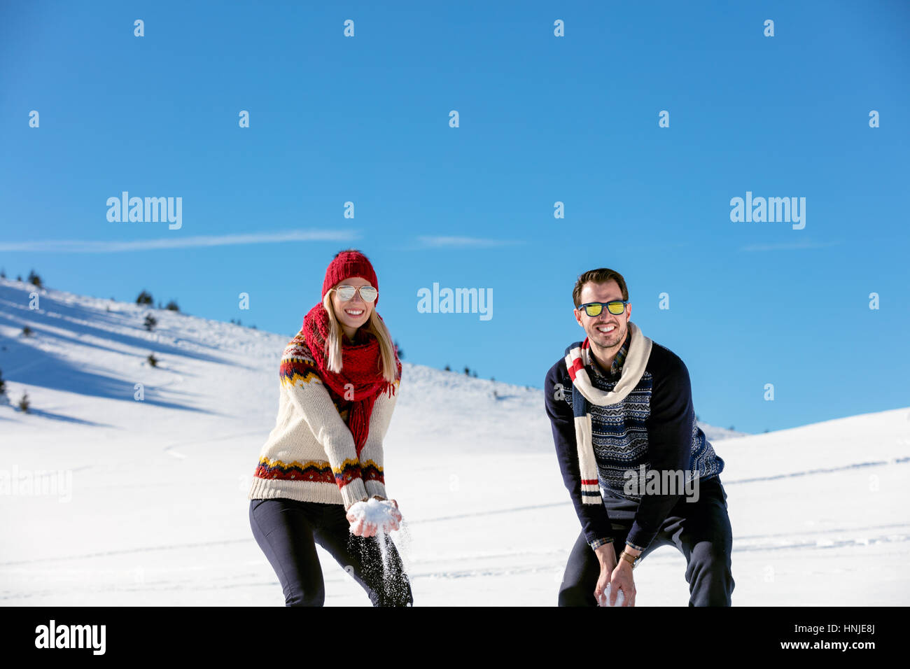 Couple enjoying snowball fight in hi-res stock photography and images ...