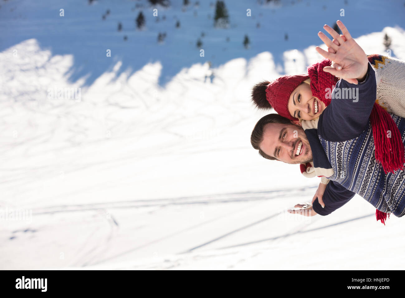 Man holding girlfriend on his back at the top of mountain Stock Photo ...