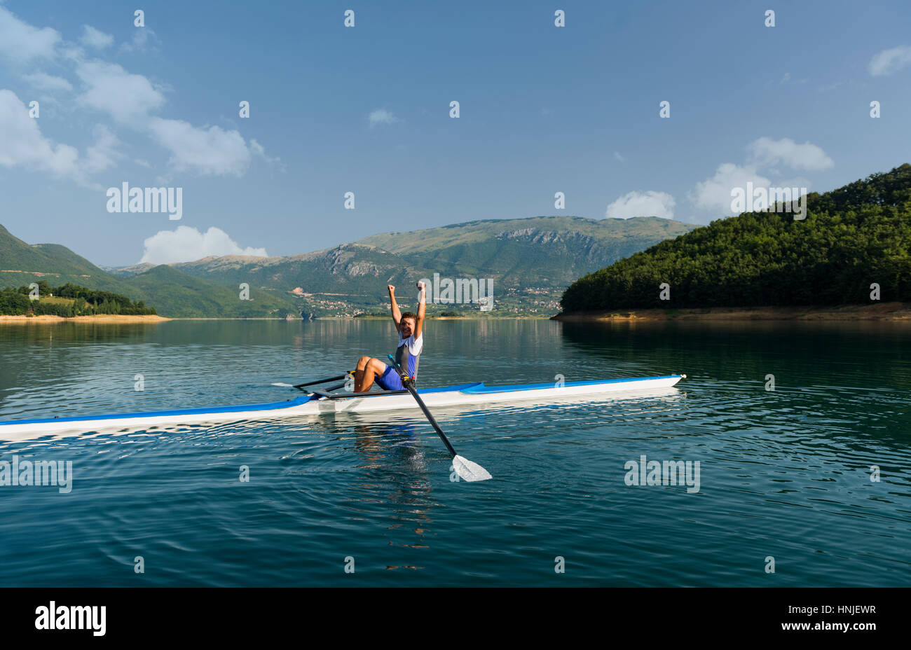 The young sportsman is rowing on the racing kayak Stock Photo - Alamy