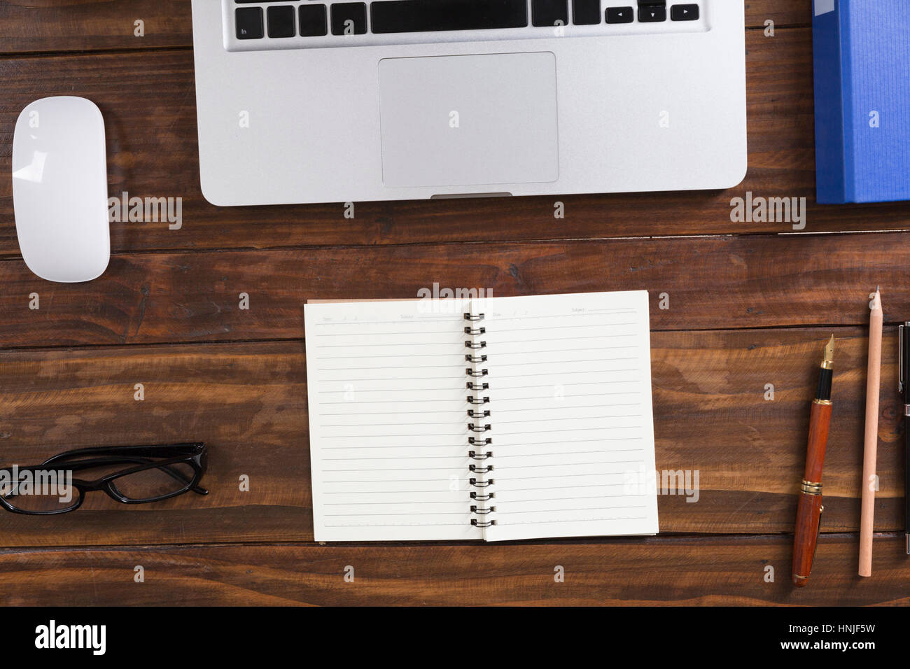 laptop computer and notepad on wooden office desk - top view Stock ...