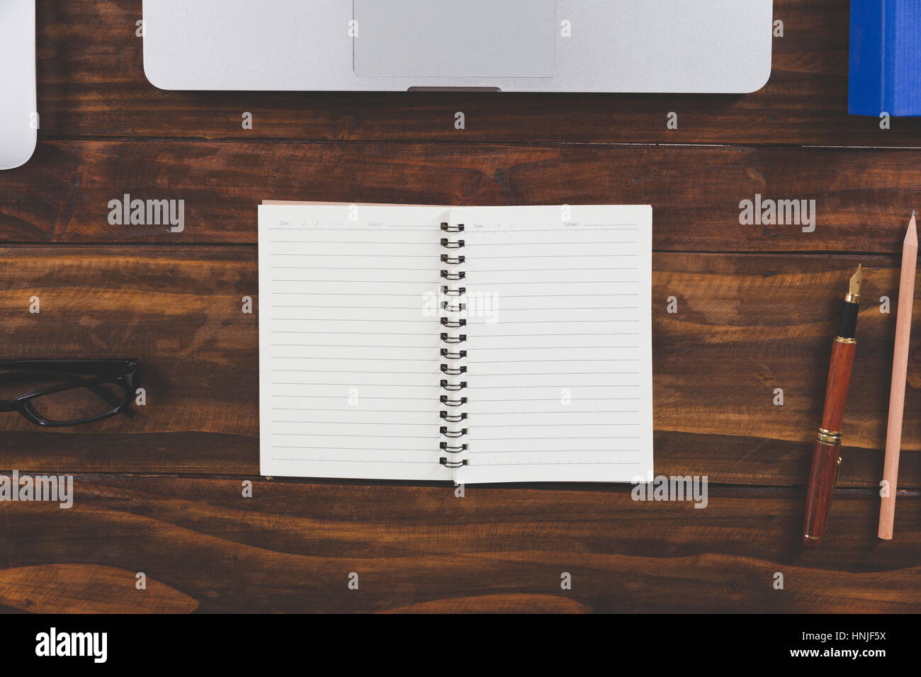 laptop computer and notepad on wooden office desk - top view Stock ...