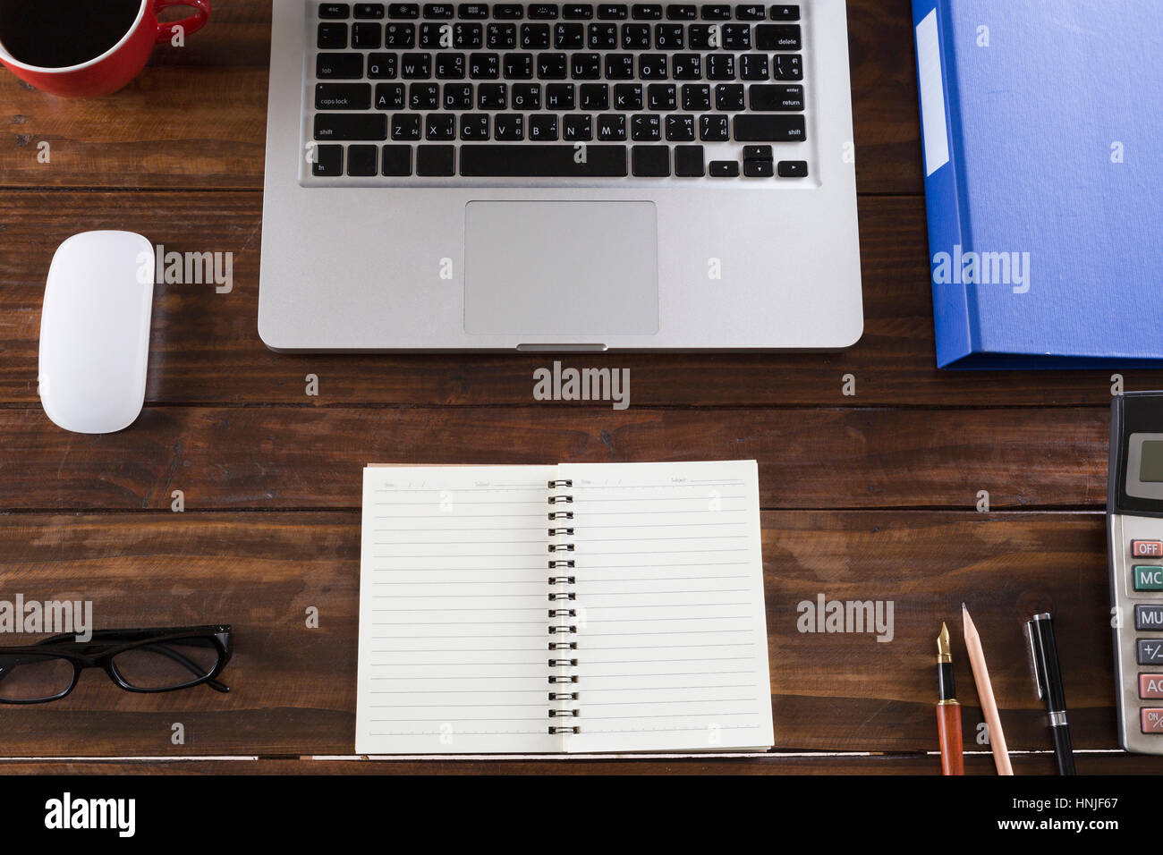 laptop computer and notepad on wooden office desk - top view Stock ...