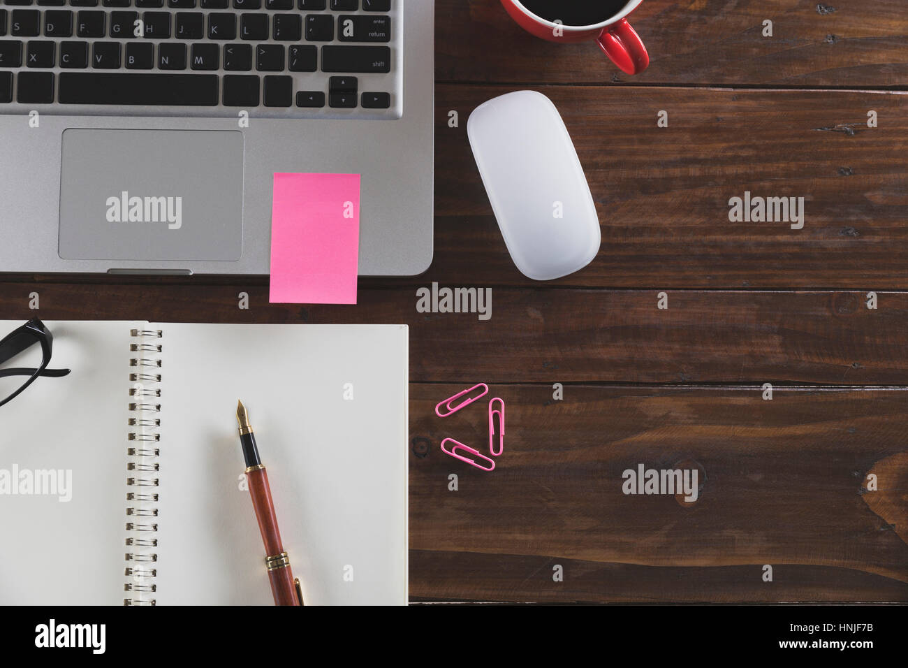 laptop computer, pen and notepad on wooden office desk - top view Stock ...