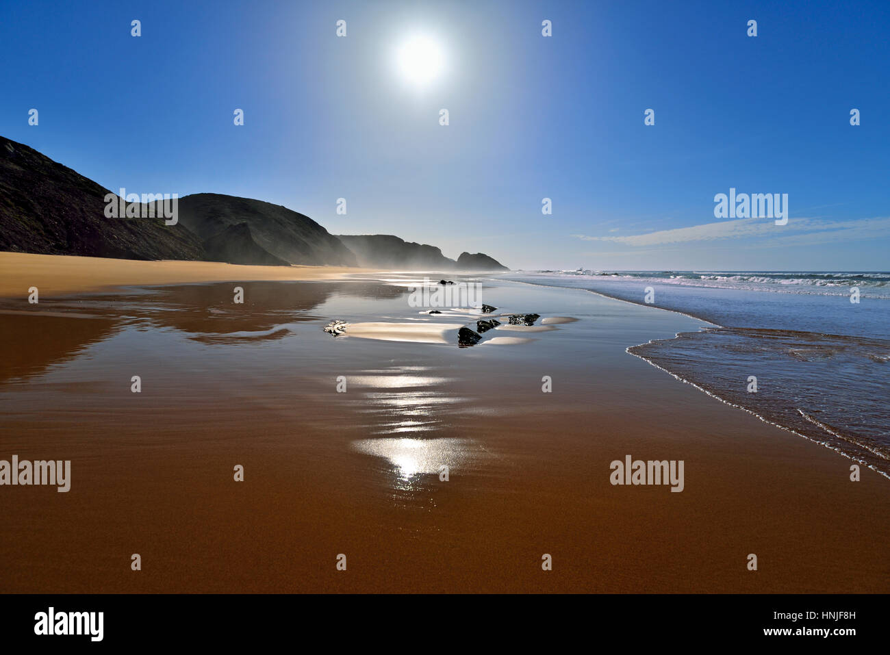 Scenic seascape at large sand beach surrounded by natural cliffs Stock ...