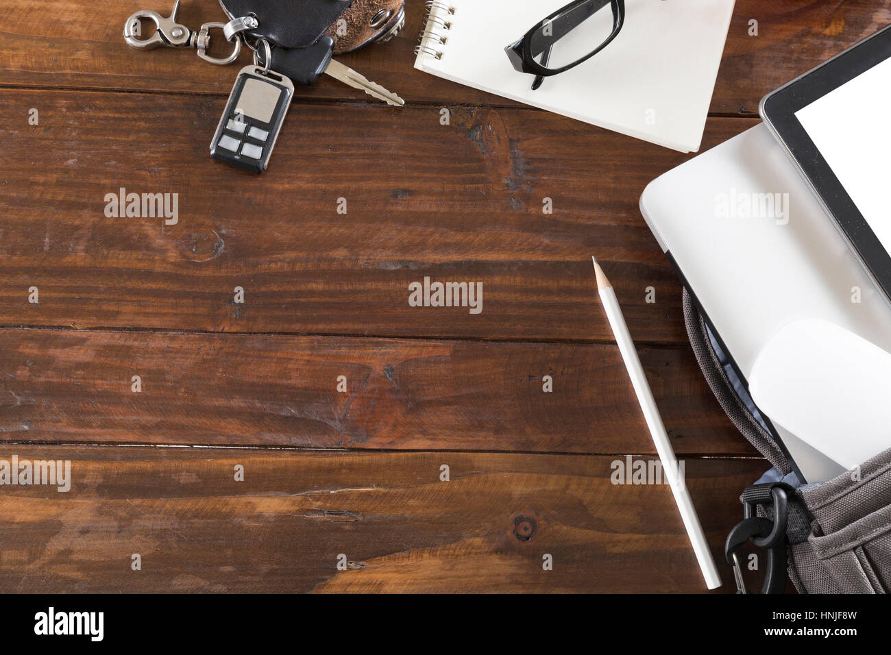 car key, laptop computer and tablet on wooden office desk - top view ...