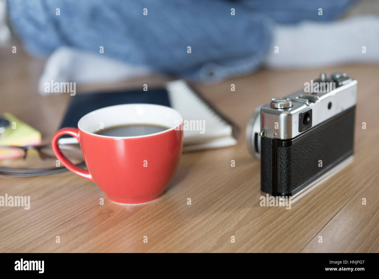 man sitting on floor with camera, coffee cup and eyeglasses Stock Photo ...