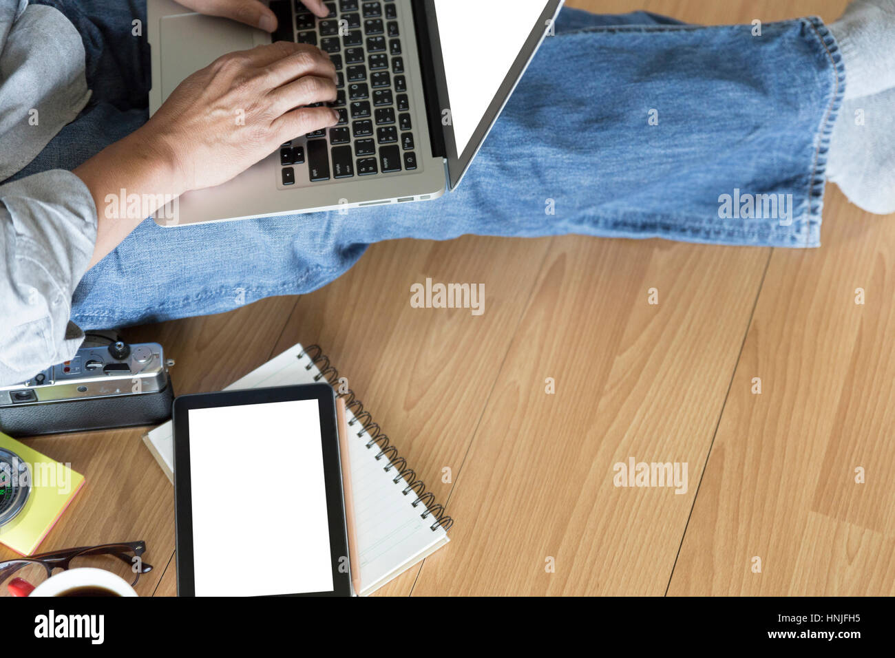 man sitting on floor with laptop computer, coffee cup and tablet Stock ...
