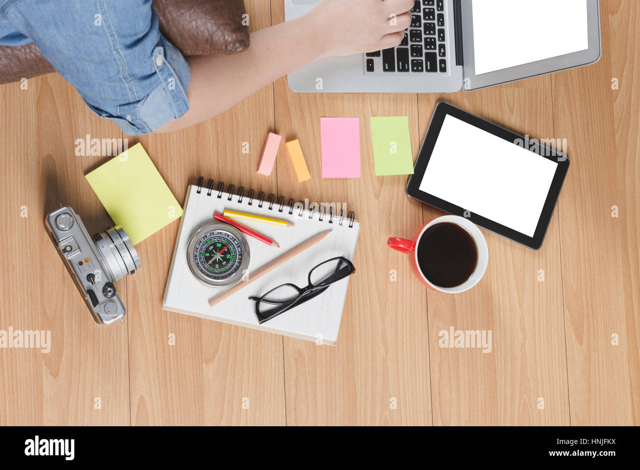 woman lying on wooden floor with computer notebook and tablet Stock ...