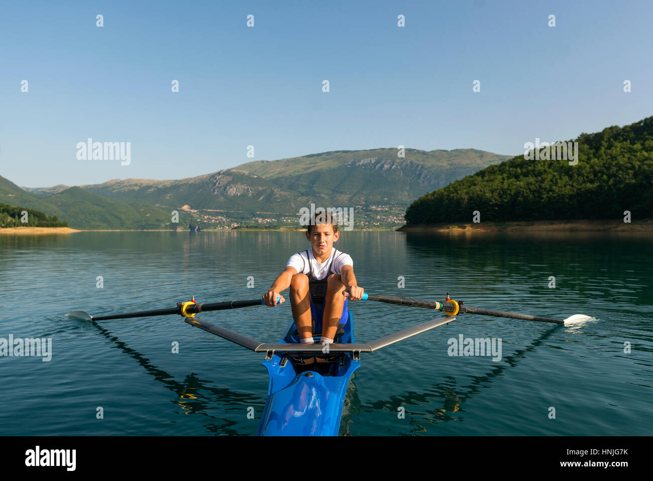 The young sportsman is rowing on the racing kayak Stock Photo - Alamy
