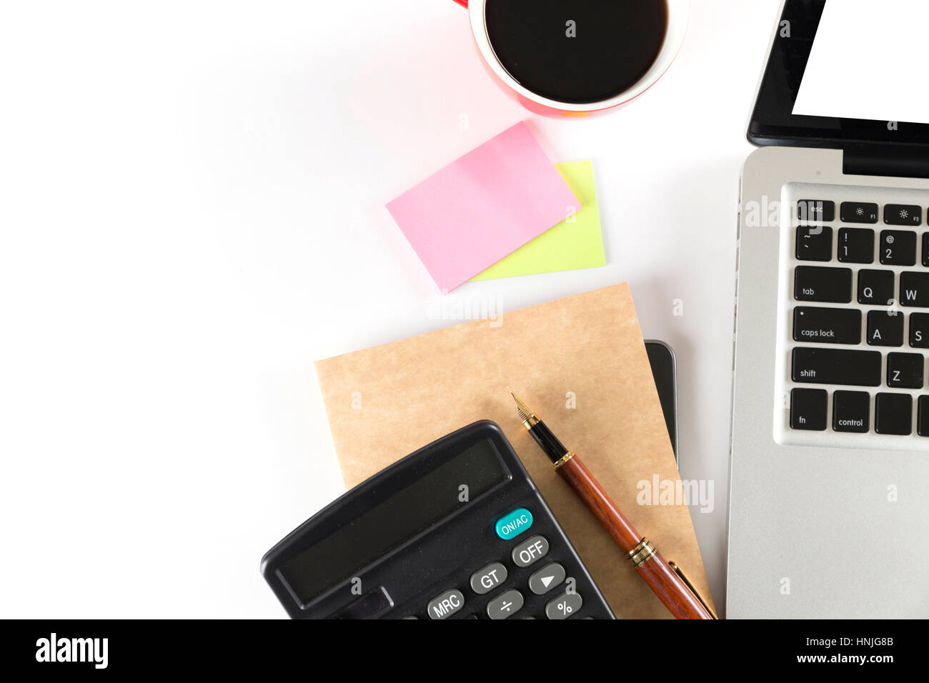 laptop computer, calculator and notebook on white background - top view ...