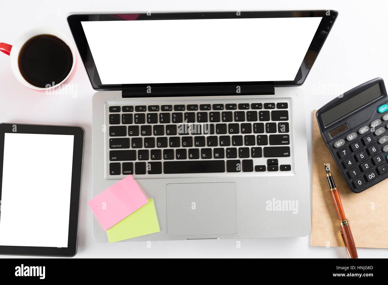 laptop computer, calculator and tablet on white background - top view ...