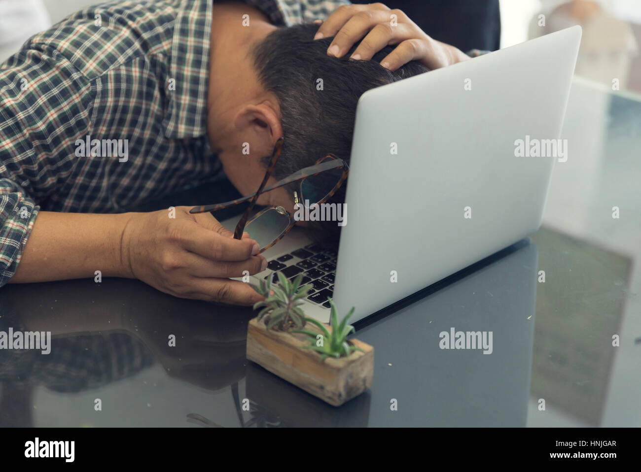 man's head on laptop computer for frustrate and stress concept ...
