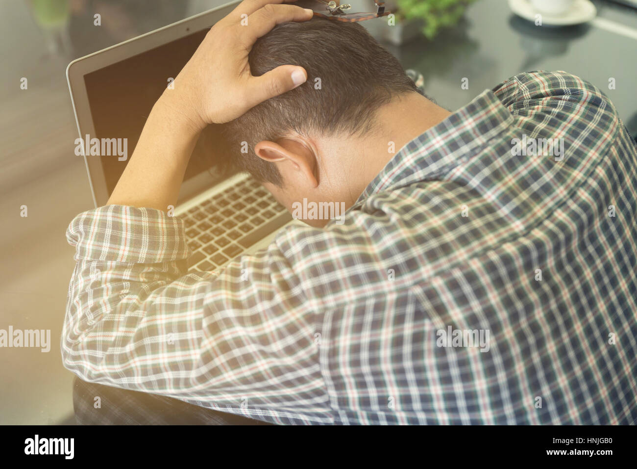 man's head on laptop computer for frustrate and stress concept ...