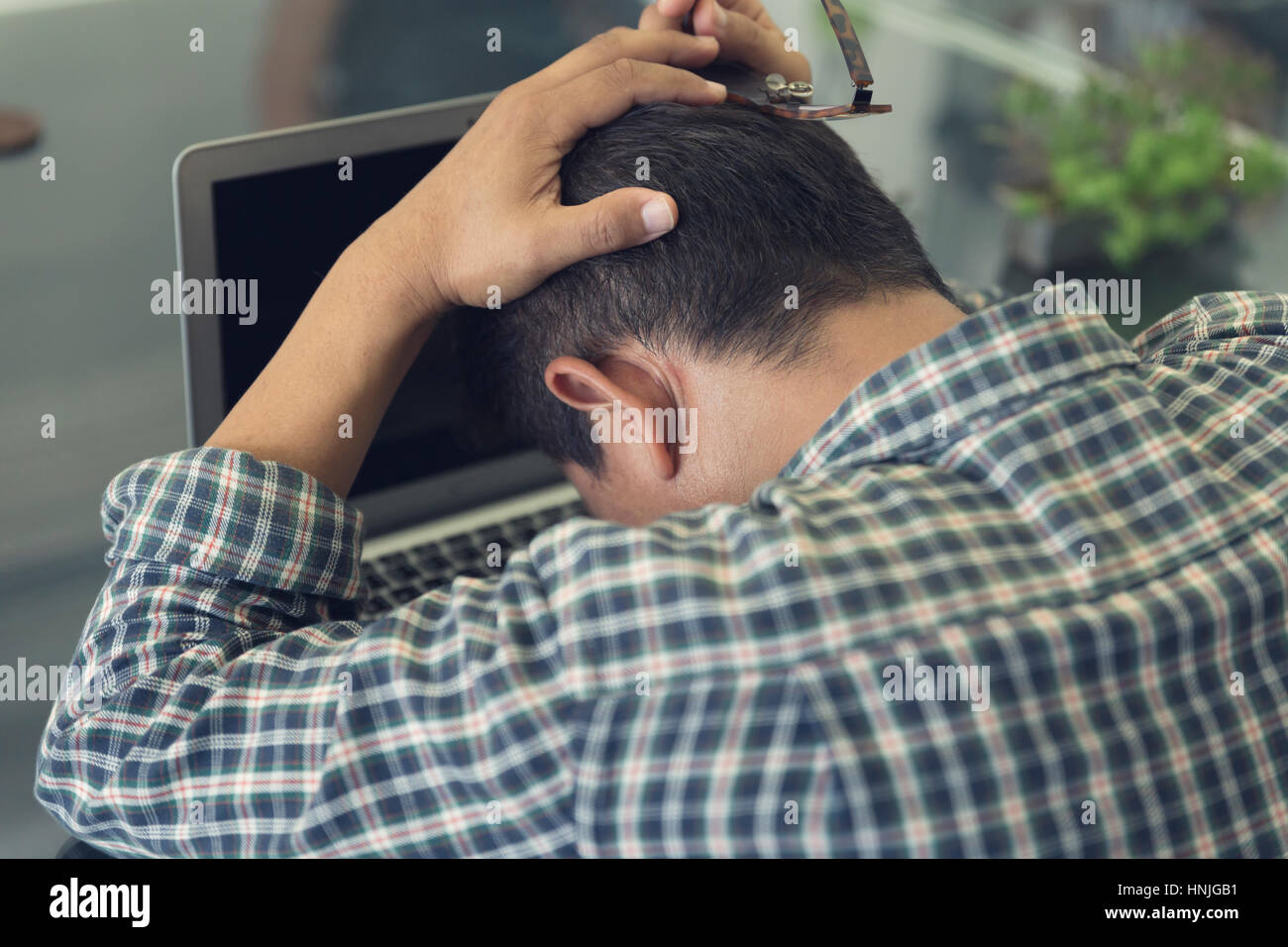 man's head on laptop computer for frustrate and stress concept ...