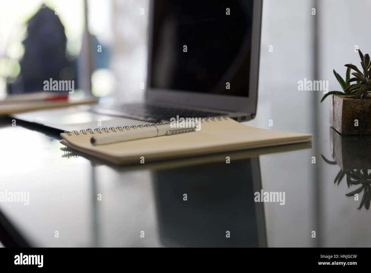 pen, notebook and laptop computer on black table for working concept ...