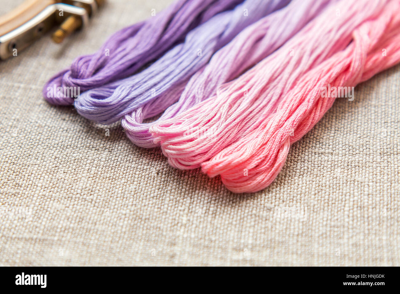 Set for embroidery. Embroidery thread shades of violet and pink color ...