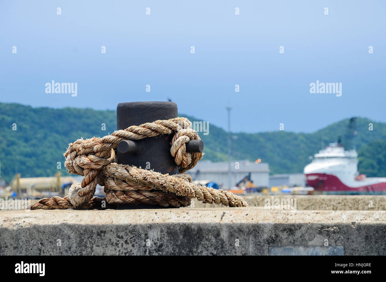 Maritime rope wrapped in iron support on a harbor Stock Photo - Alamy