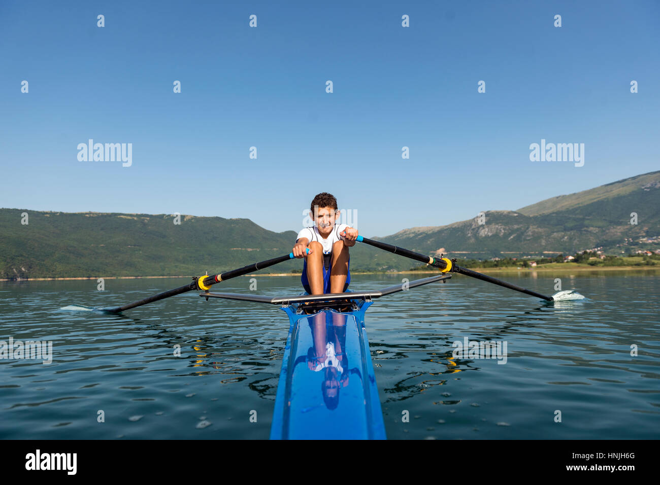 The young sportsman is rowing on the racing kayak Stock Photo - Alamy