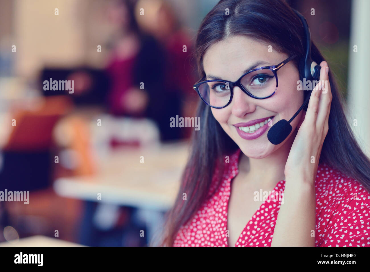 Young female in call center team Stock Photo - Alamy