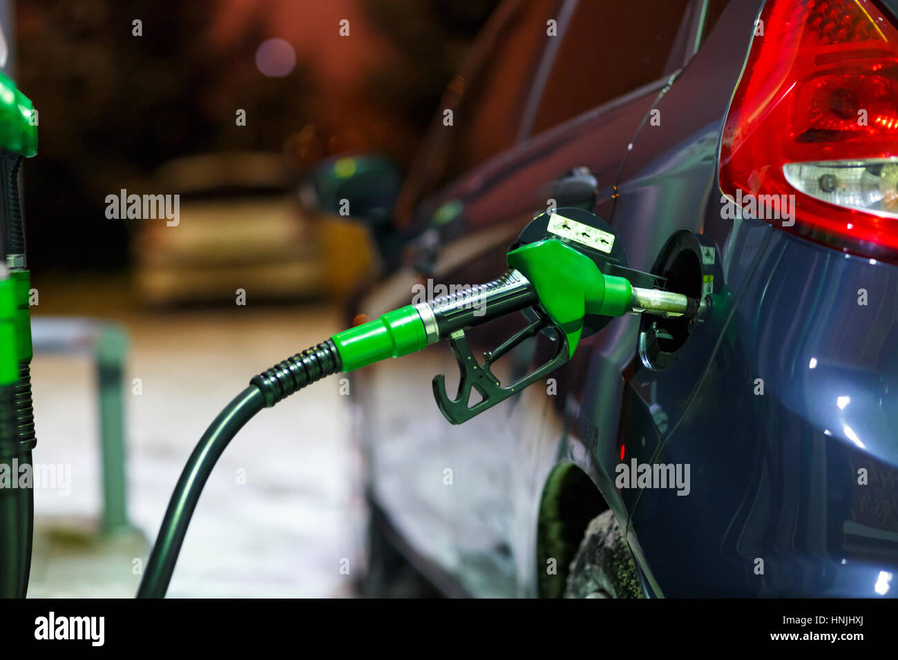 Car refueling on a petrol station in winter at night closeup Stock ...