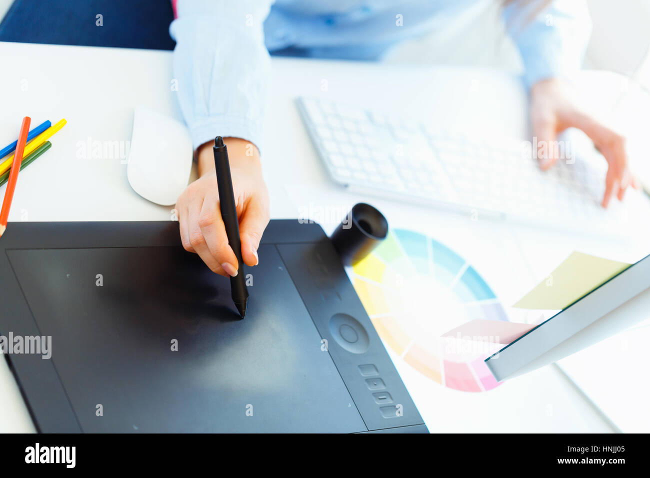 Graphic designer drawing something on graphic tablet at the office ...