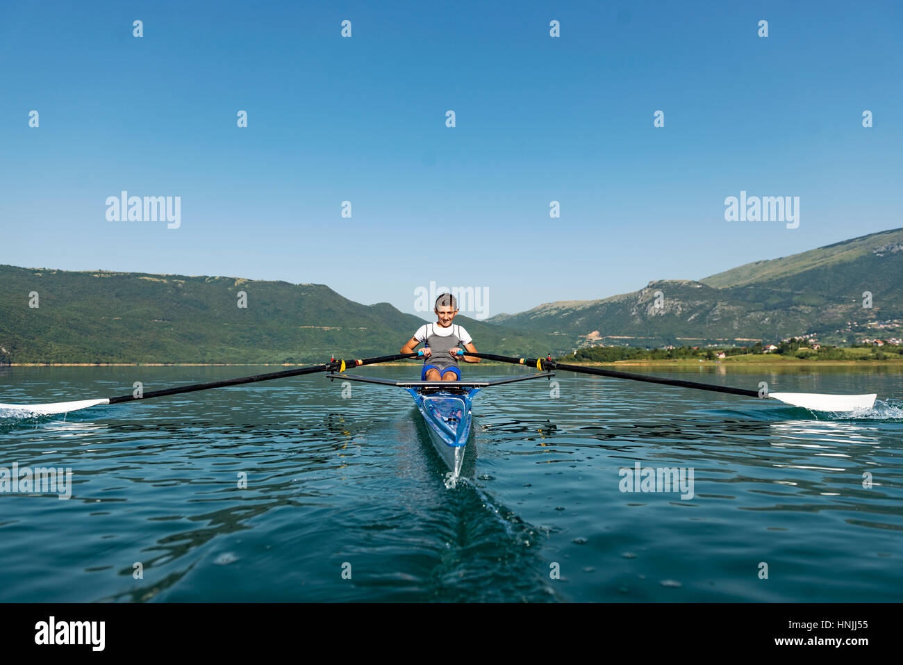 The young sportsman is rowing on the racing kayak Stock Photo - Alamy
