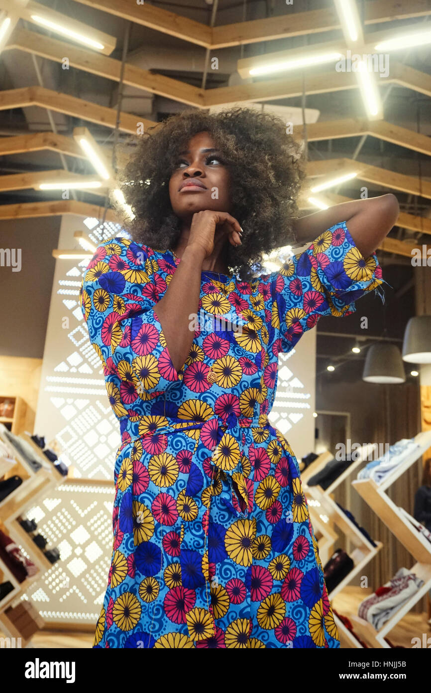 Beautiful afro-american wooman standing in a clothing shop Stock Photo ...