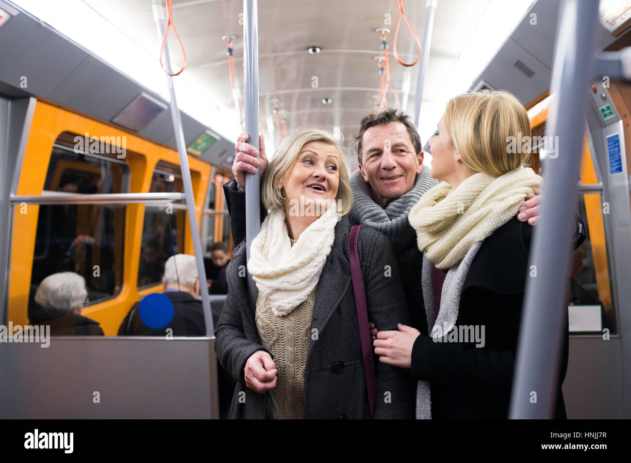 Beautiful family in winter clothes traveling by subway train Stock ...